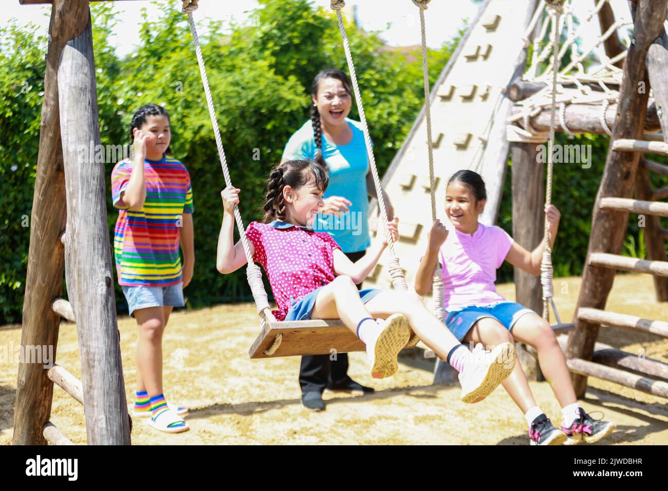 Group of happy children playing at playground Stock Photo - Alamy