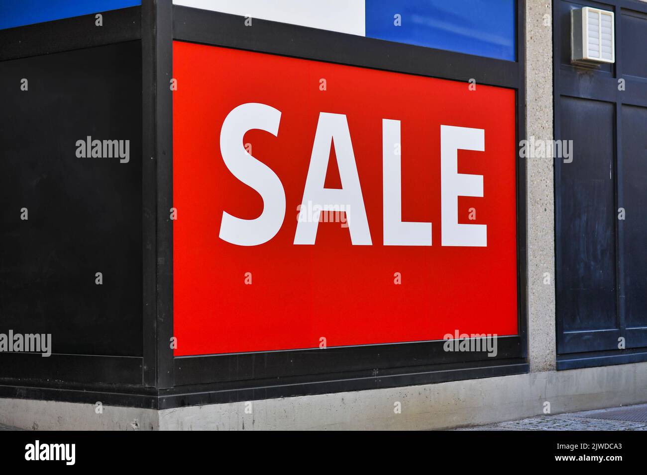 Large red SALE sign in front of shop Stock Photo - Alamy