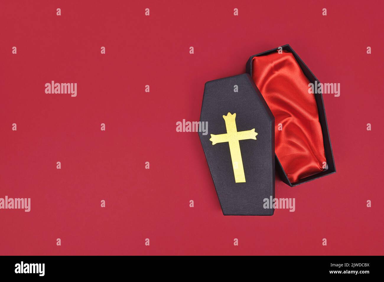Coffin shaped Halloween cardboard gift box on red background with copy ...