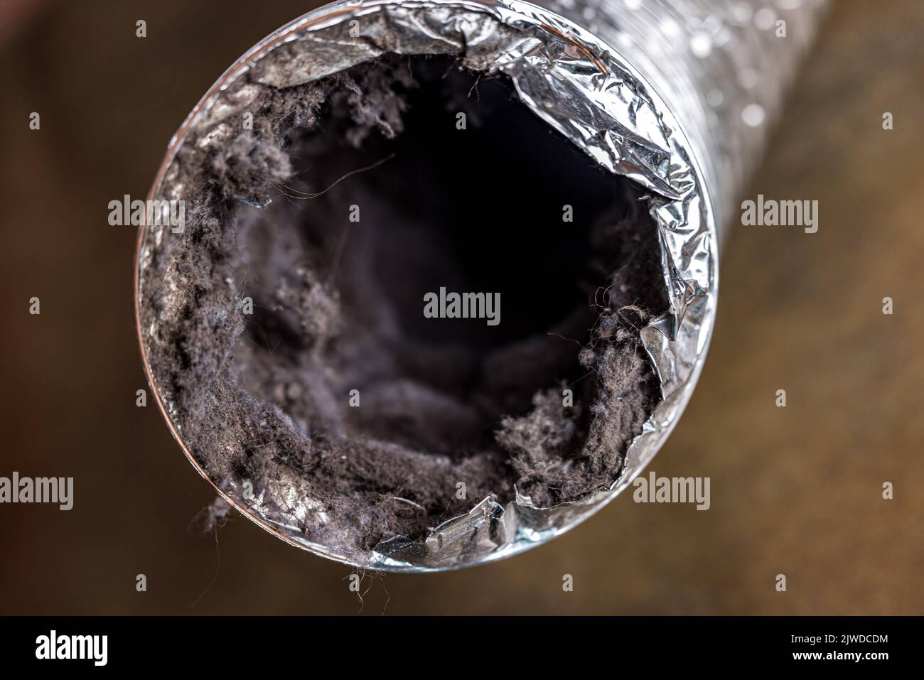 A dirty laundry flexible aluminum dryer vent duct ductwork filled with ...