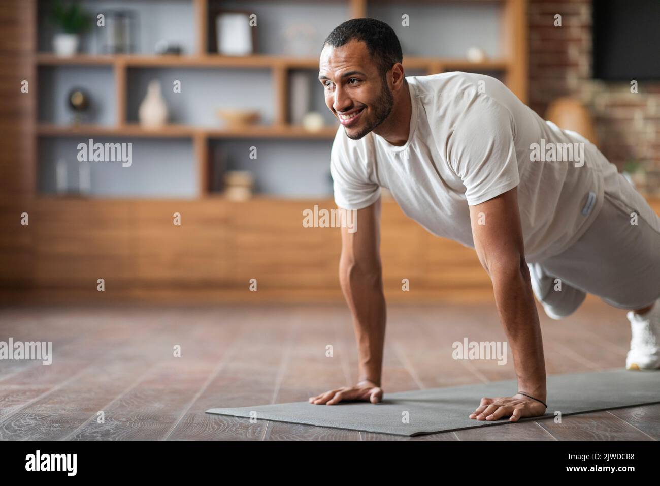 Active Sporty Black Male Training At Home, Making Plank Exercise Stock ...