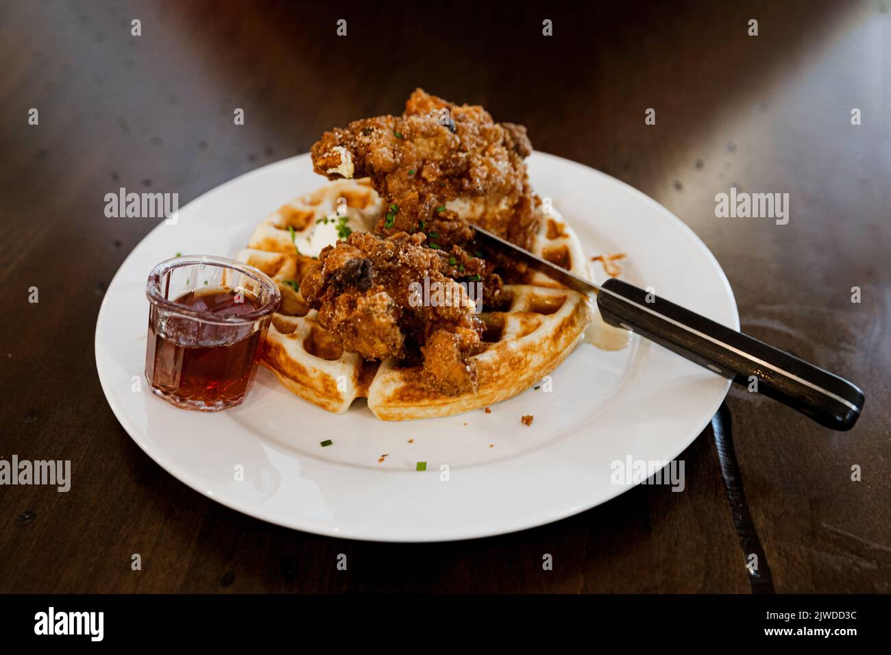 A plate of fried chicken strips and waffles and maple syrup Stock Photo ...
