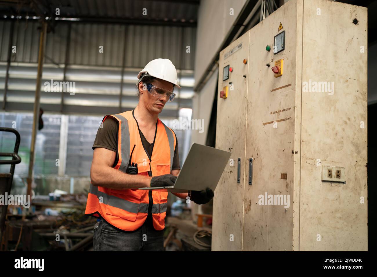 Metal industry worker dressed in work wear doing some metalwork ...