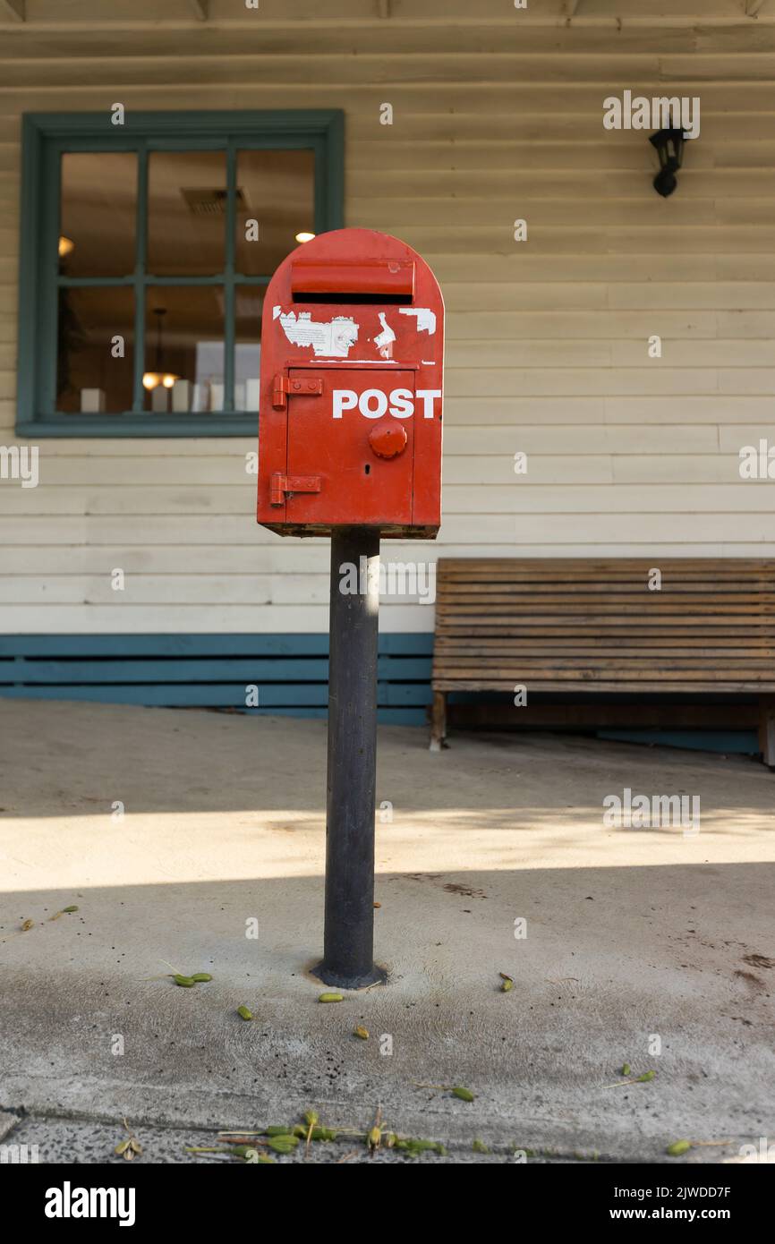 A red australia post letter box stripped of all branding and logos ...