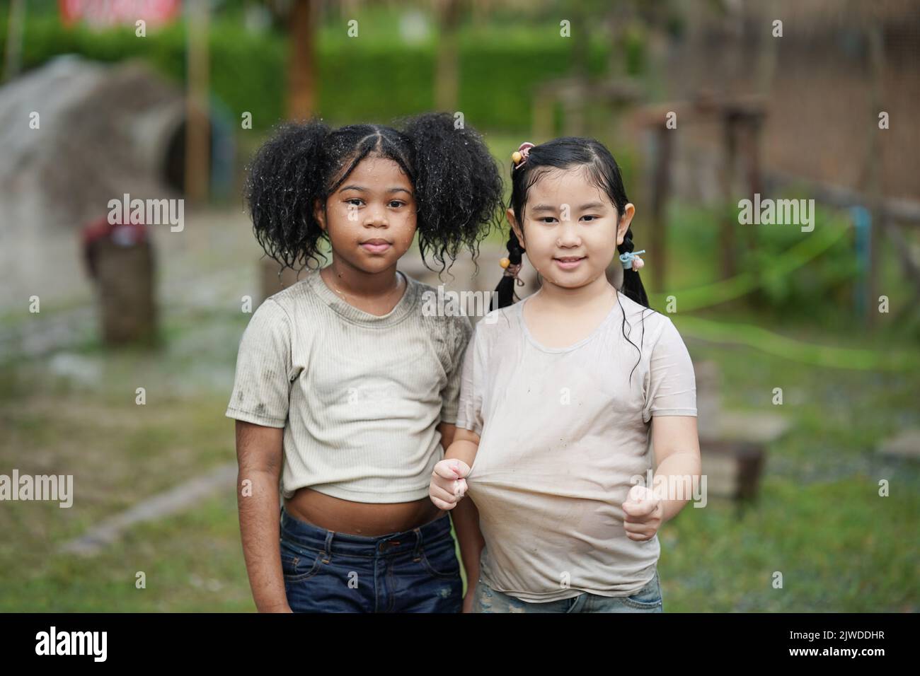 Group of kids playing on muck in the raining day Stock Photo - Alamy