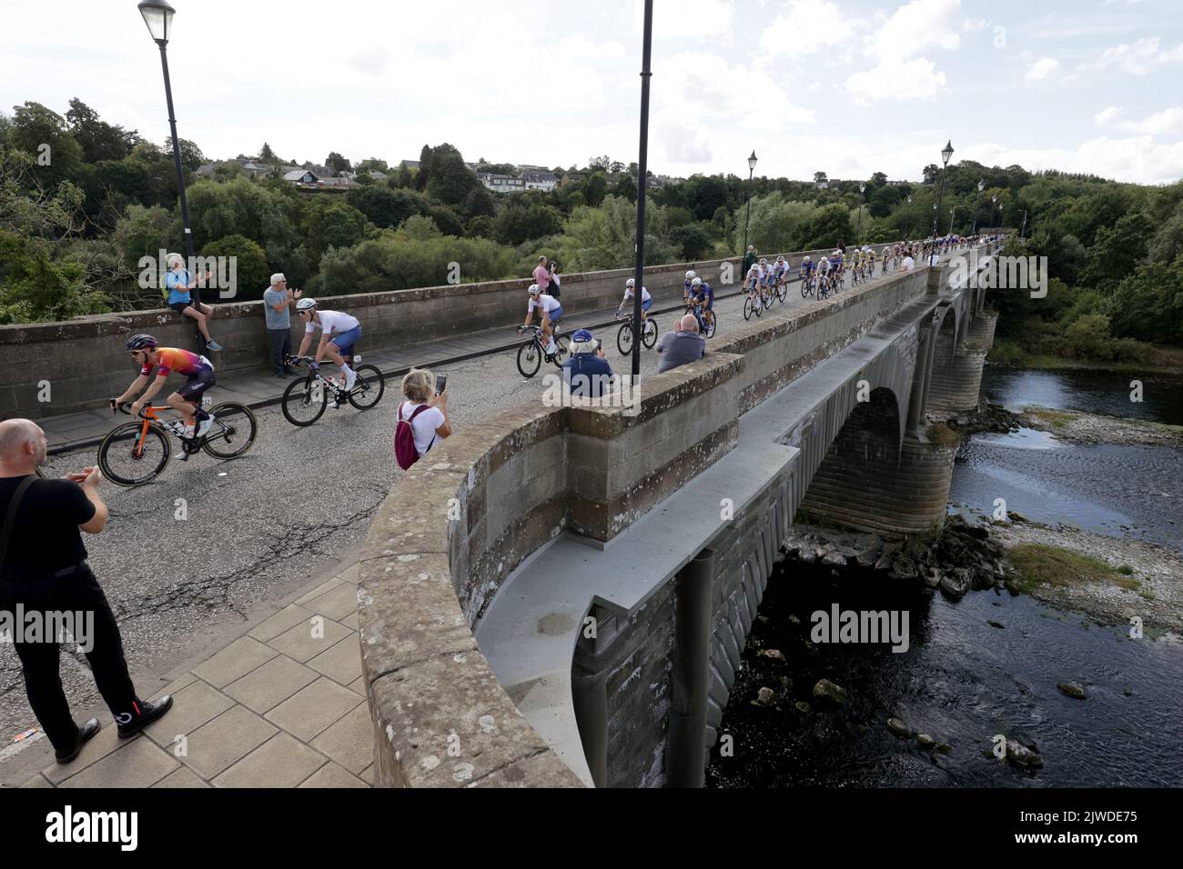 Riders cycle over Kelso Bridge across the River Tweed at Kelso, in the ...
