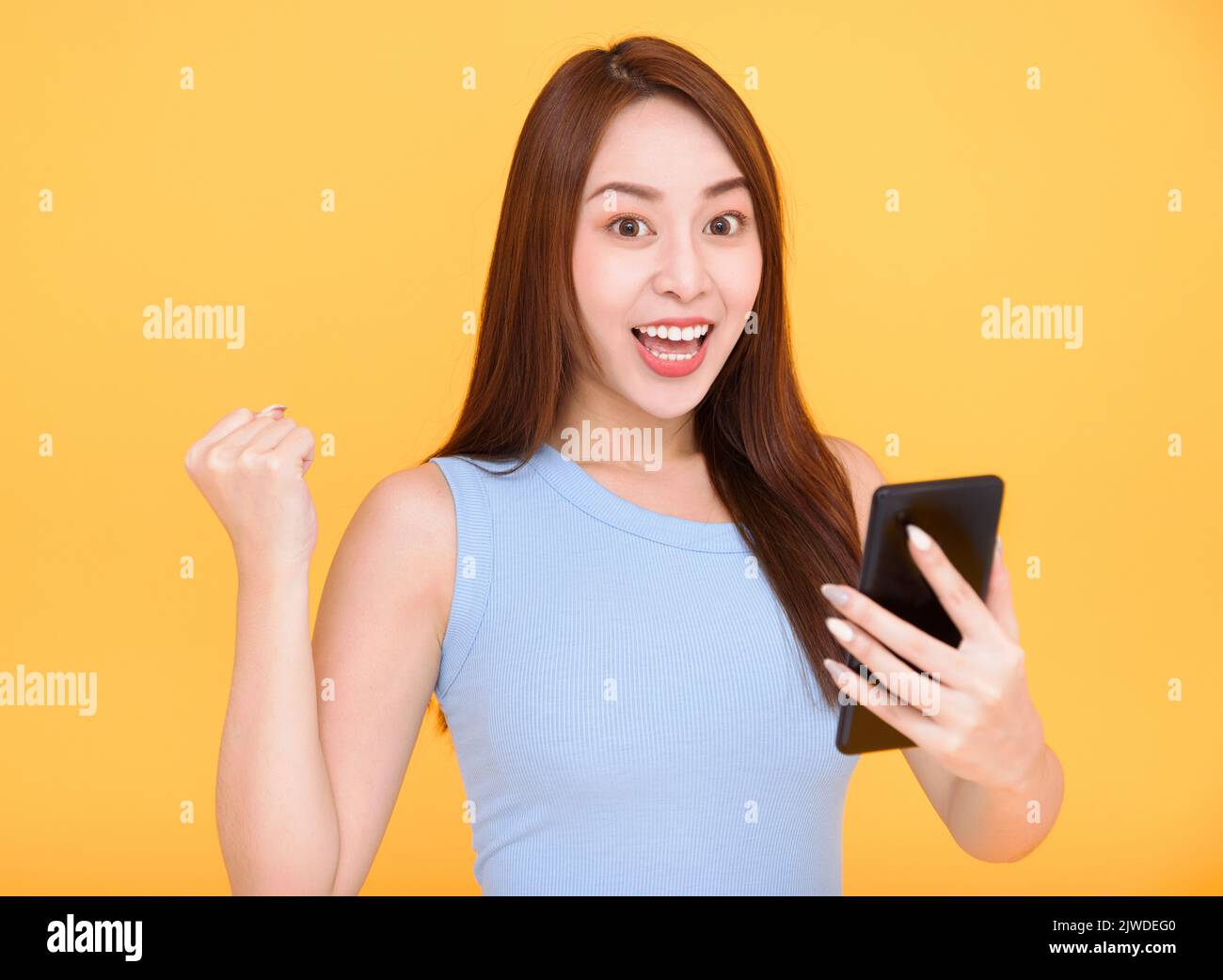 Happy young celebrating success hi-res stock photography and images - Alamy