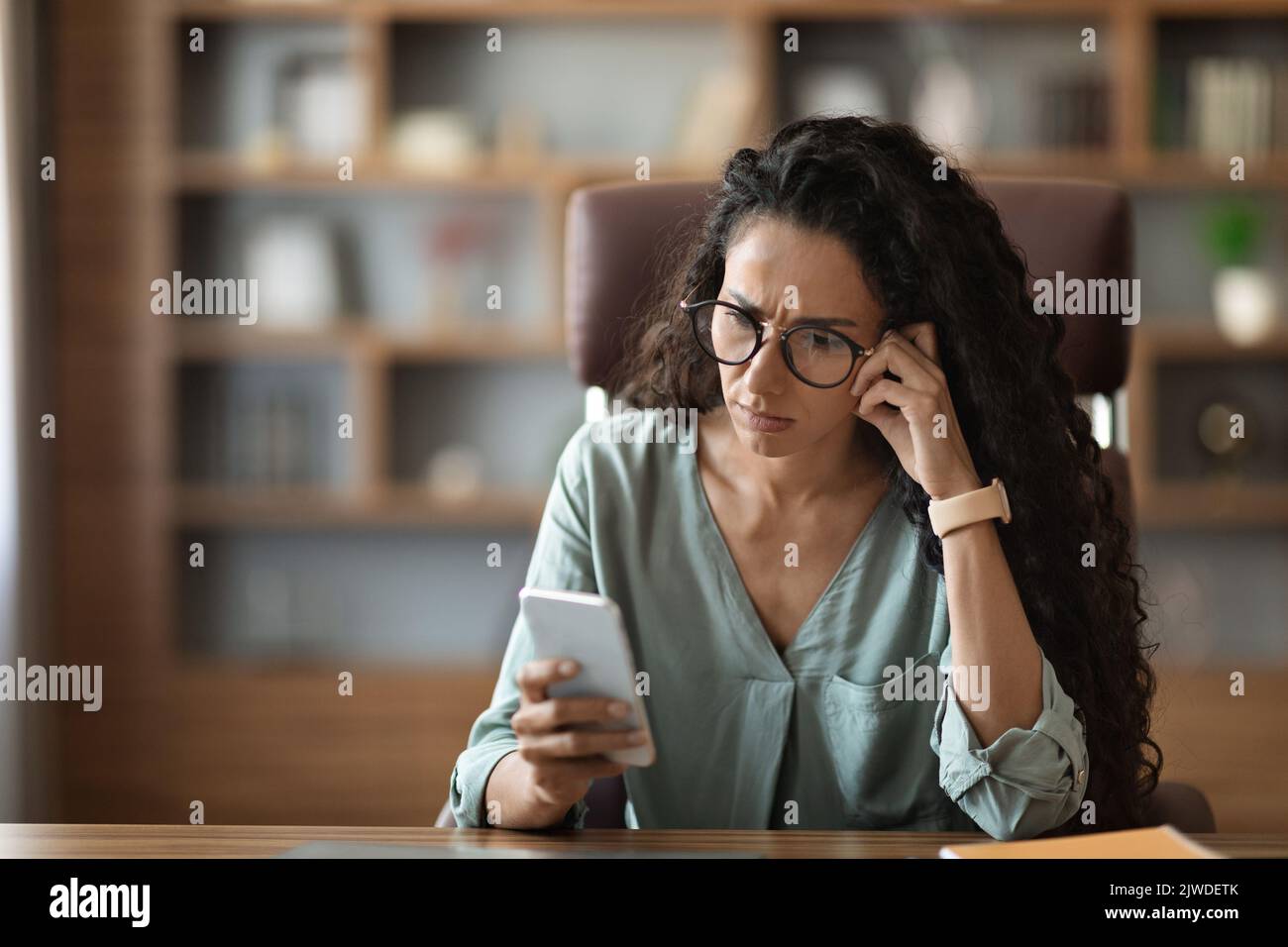 Woman scrolling smartphone desk hi-res stock photography and images - Alamy
