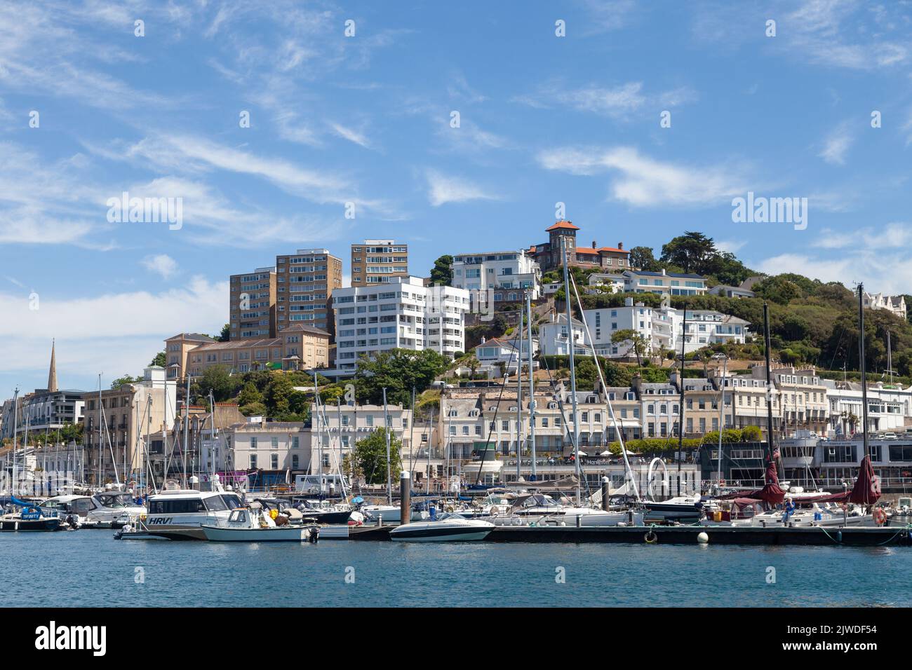 Boats moored in Torquay Marina with the town of Torquay in the ...