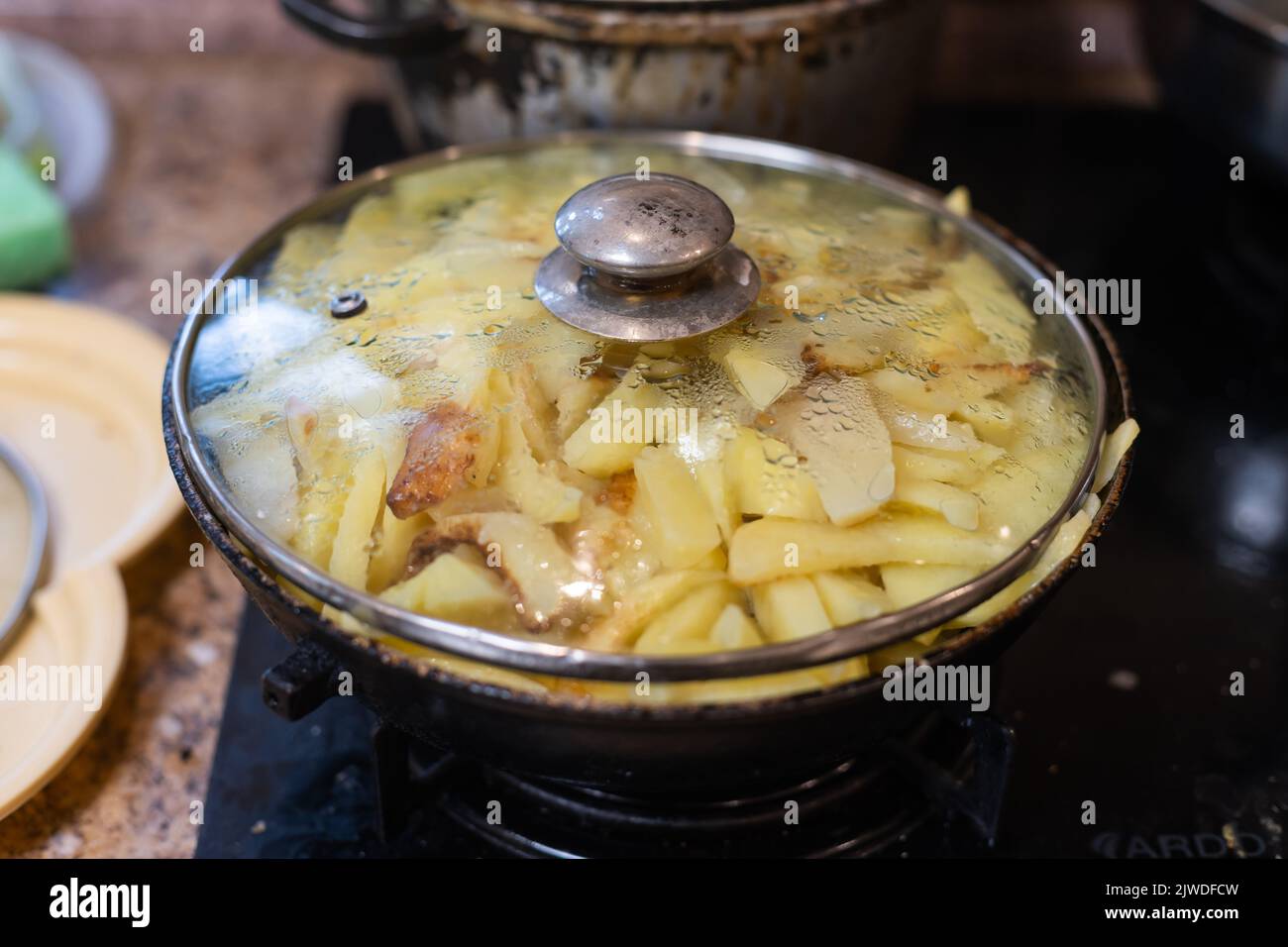 Frying potato cubes in pan hi-res stock photography and images - Alamy