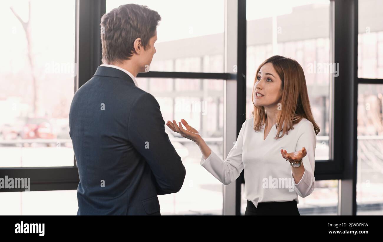 emotional woman gesturing during job interview with businessman in ...