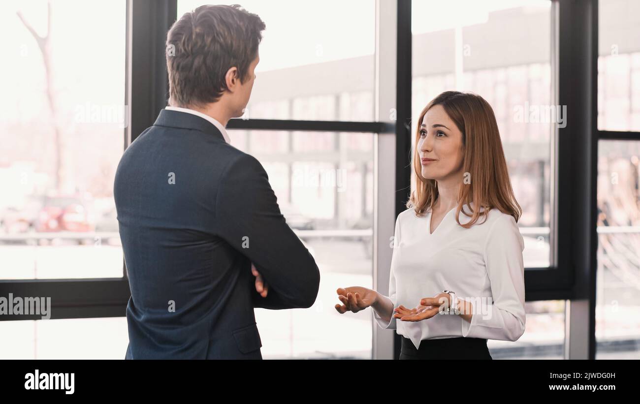 surprised and positive woman talking to employer during job interview ...