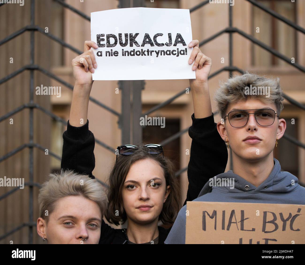 A student holds a sign with the words 'Education not indoctrination ...