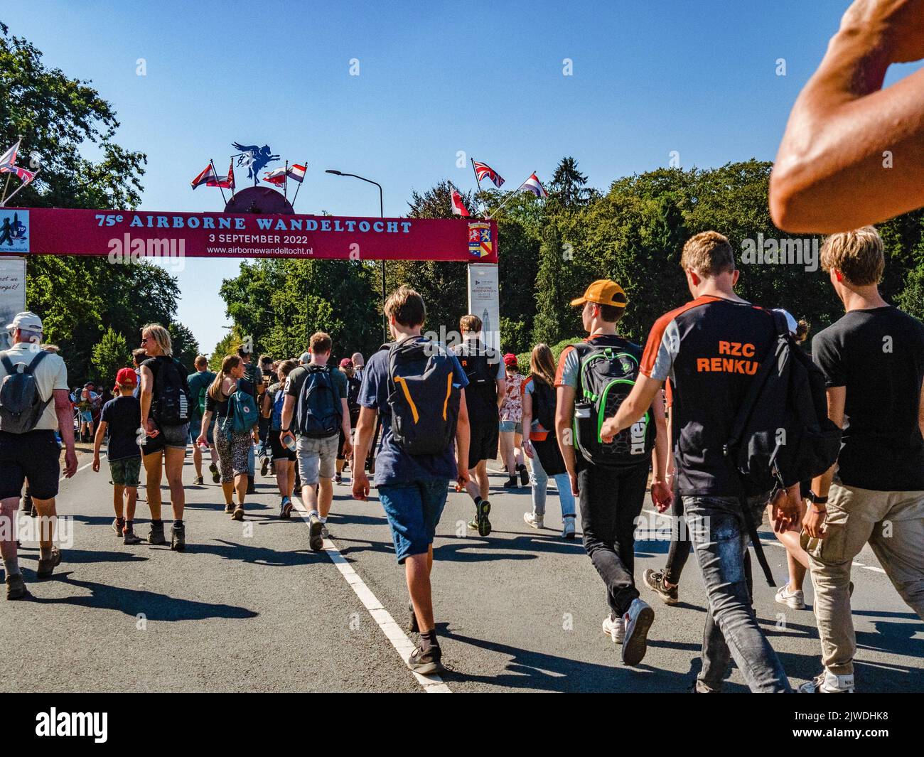 People of all ages are seen arriving at the finish line. The Airborne ...