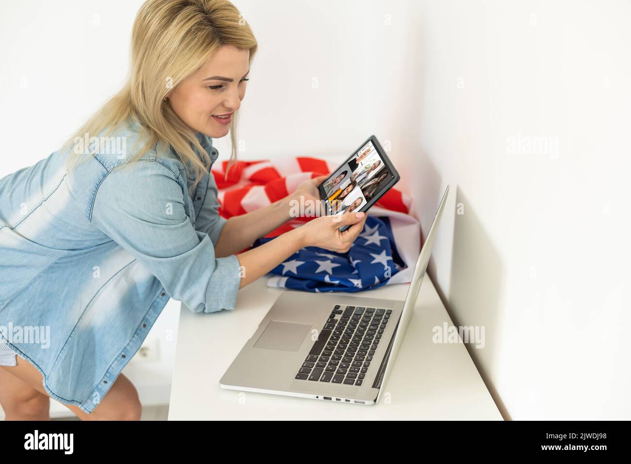 Happy woman employee sitting wrapped in USA flag, shouting for joy in ...