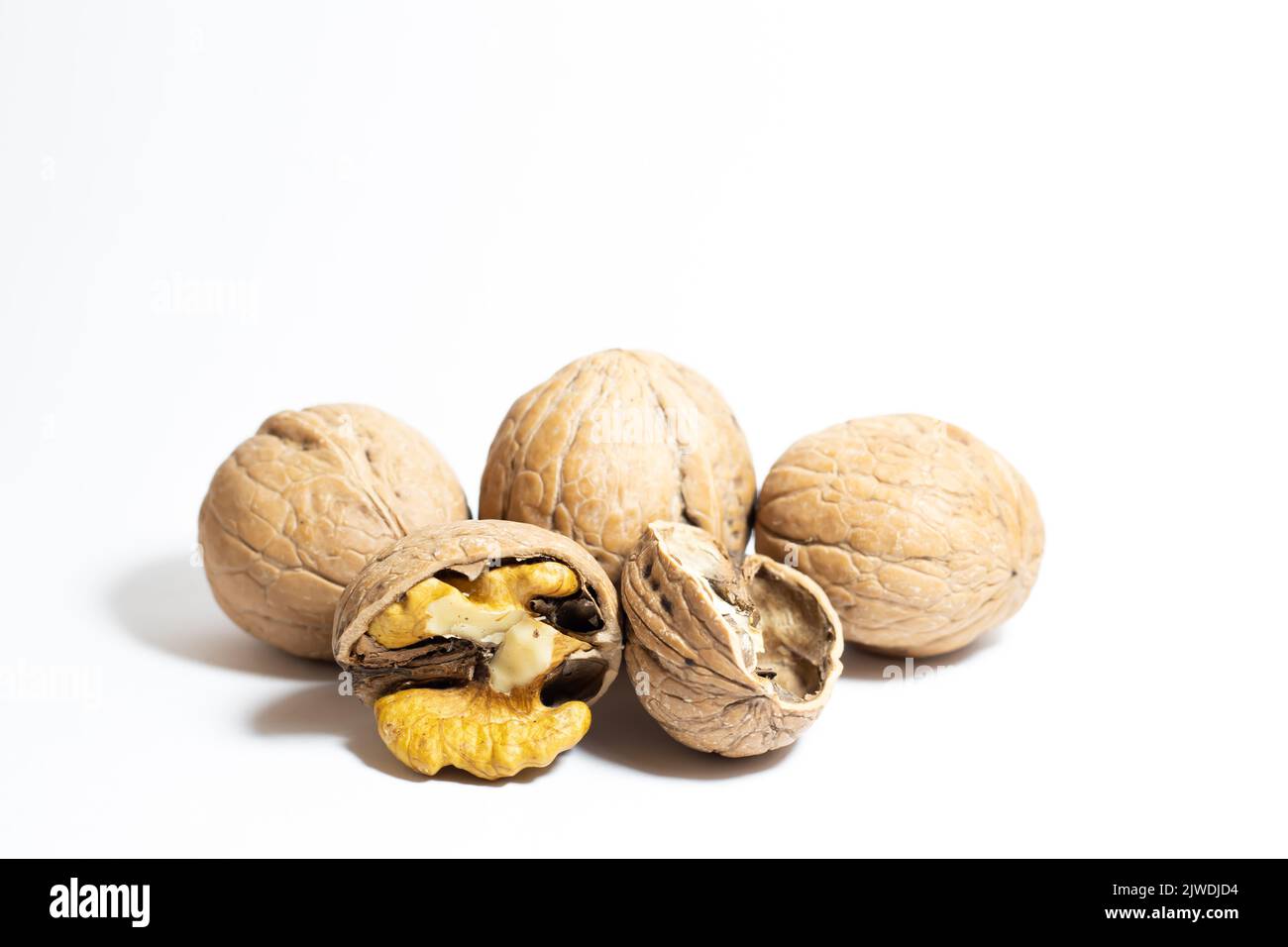 Walnuts isolated on a white background. Peeled and unpeeled walnuts ...