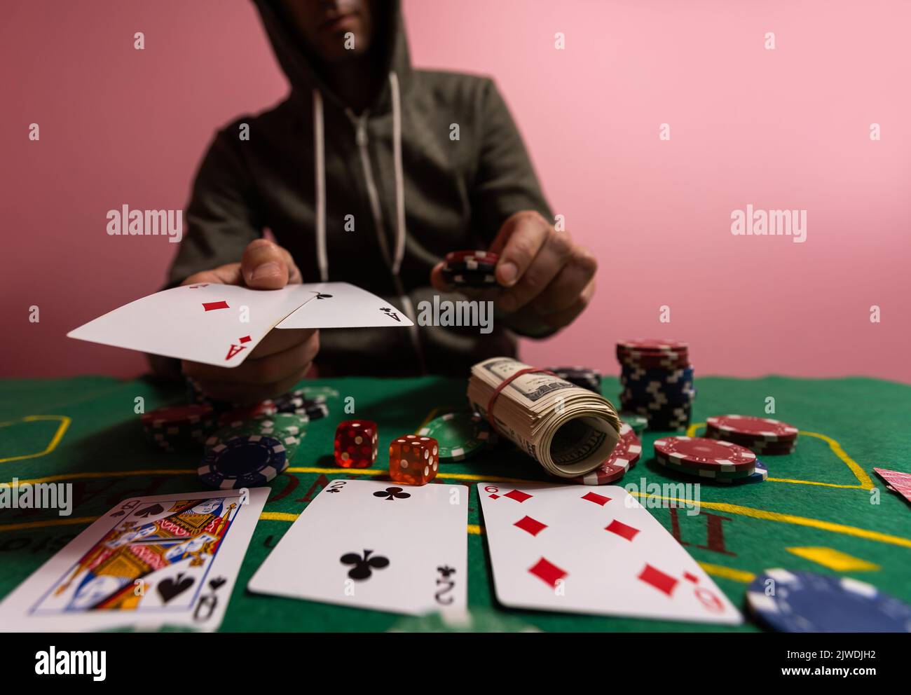 Happy poker player winning and holding cards Stock Photo - Alamy
