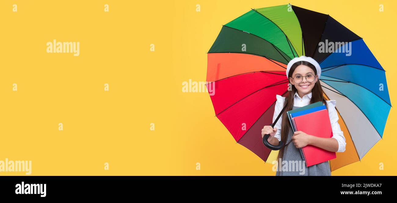 education. teen child under colorful parasol. kid in beret with rainbow ...