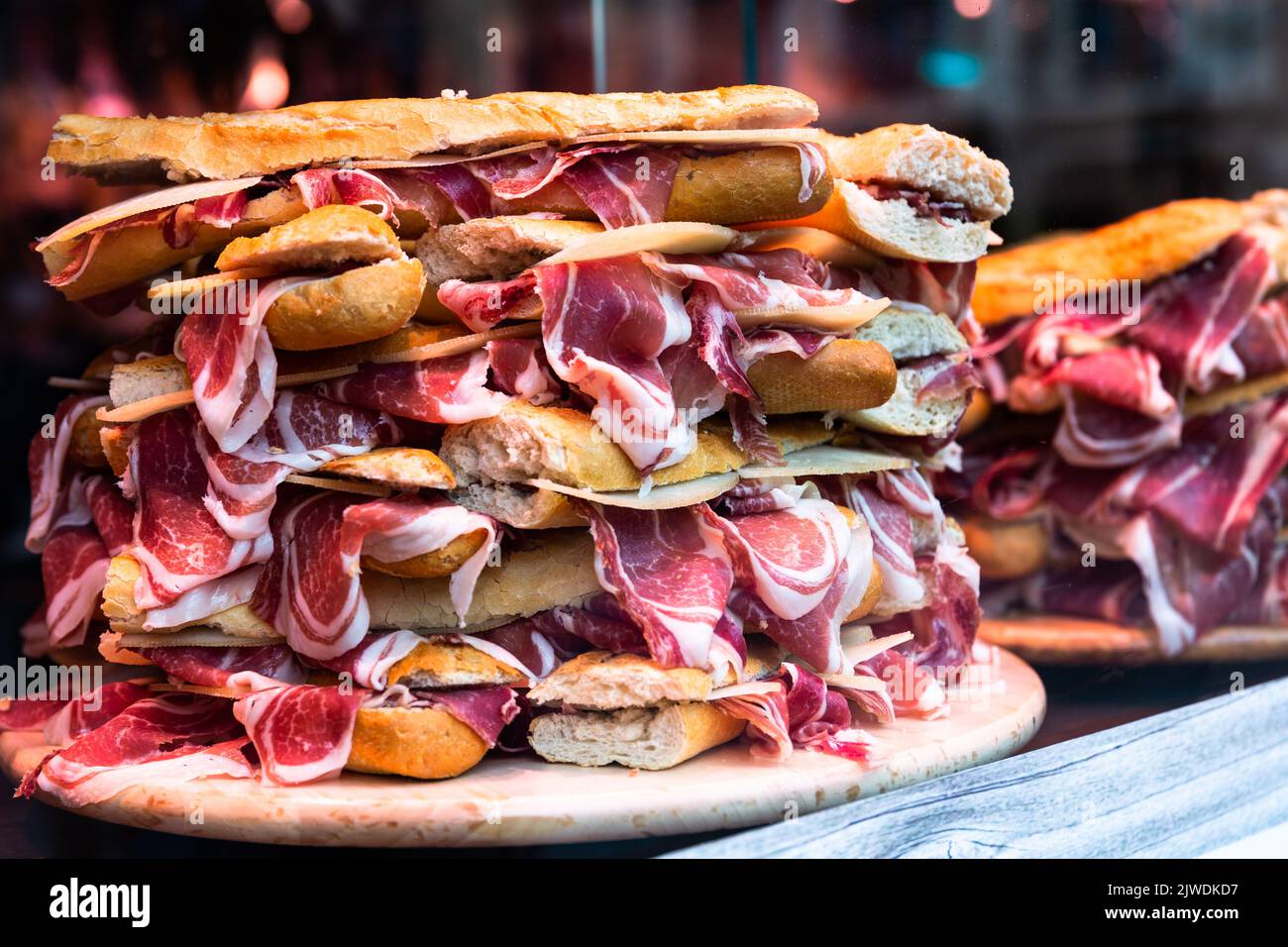mouth watering sandwiches with jamon laid out in a slide on shop window ...
