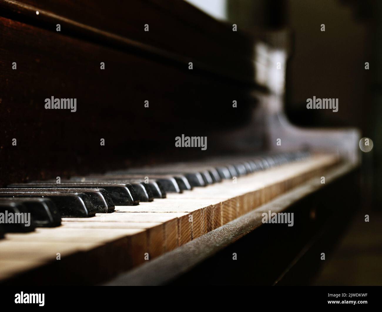 A closeup shot of the piano music instrument in the dark room with ...