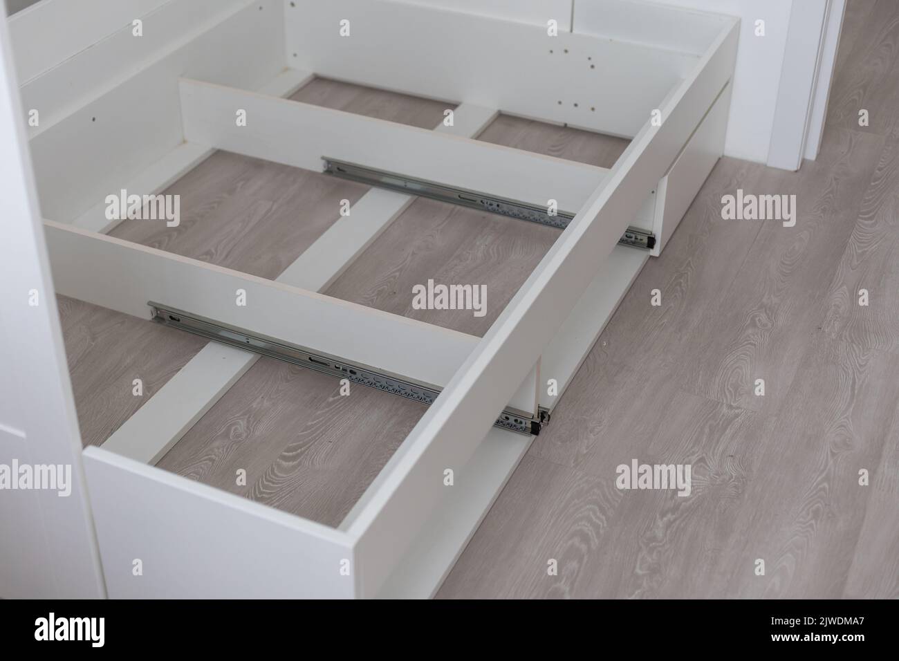 disassembled wooden bed on the floor Stock Photo - Alamy