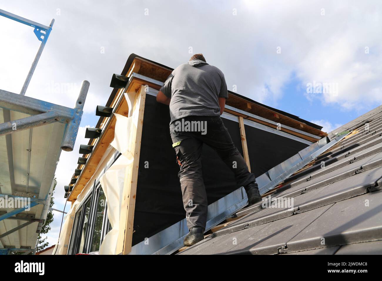 Roofing contractor working on a new dormer Stock Photo - Alamy