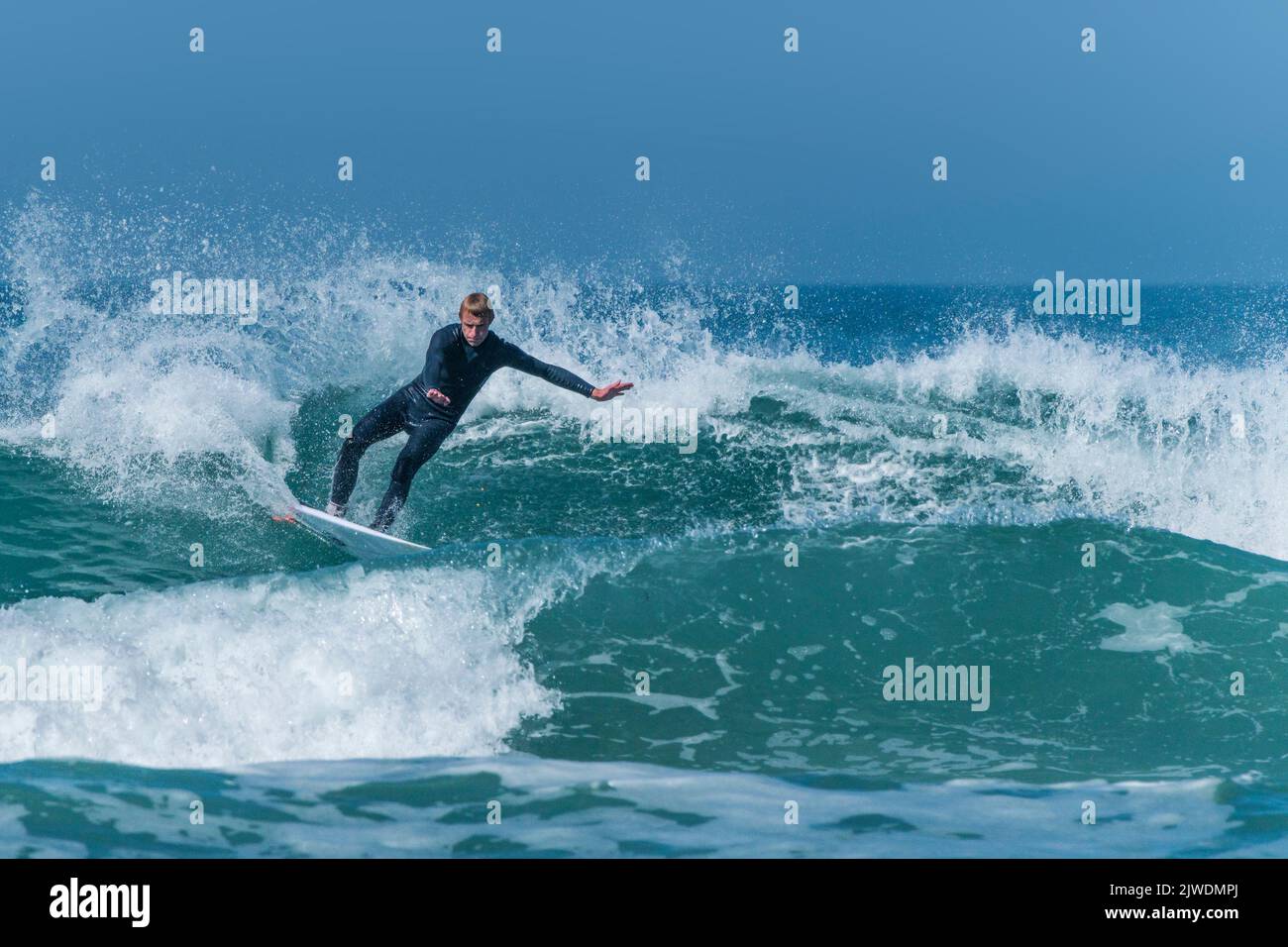 Spectacular surfing action as a surfer rides a wave at Fistral in ...