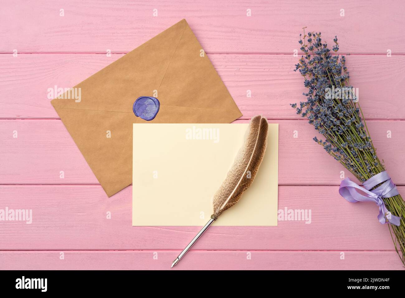 Envelope with letter on pink wooden background top view Stock Photo - Alamy
