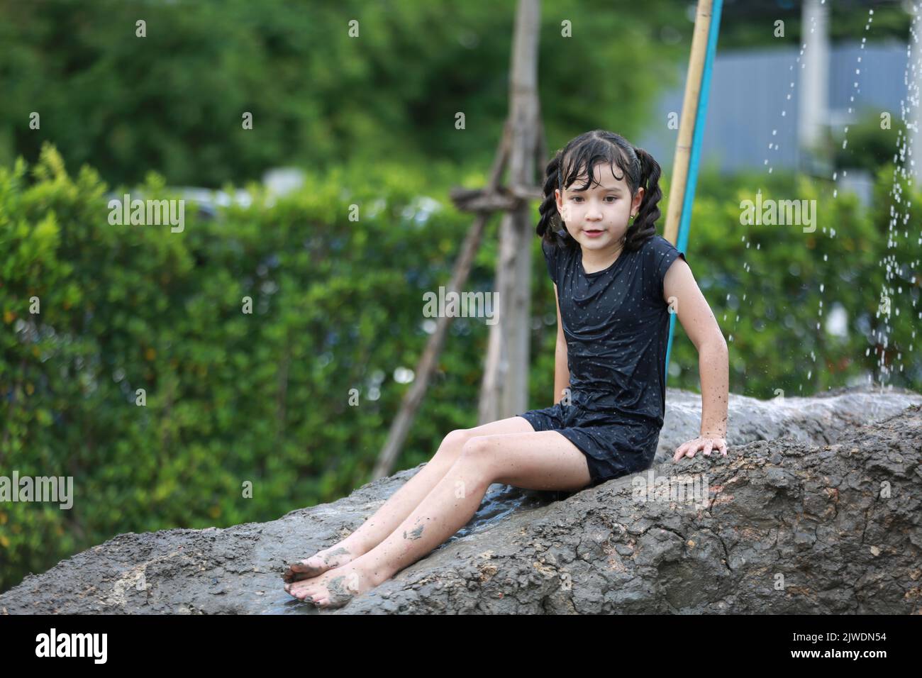Group of kids playing on muck in the raining day Stock Photo - Alamy
