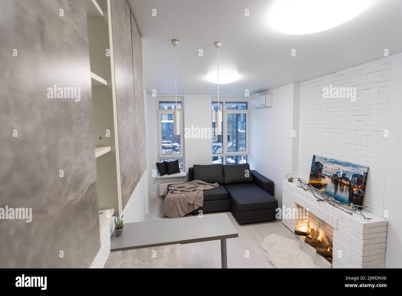 Modern studio flat with small kitchen, sofa Stock Photo - Alamy