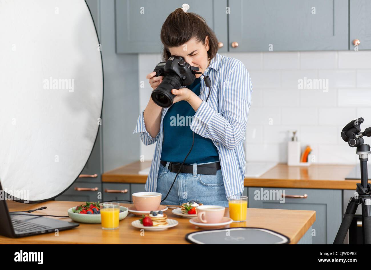 food photographer with camera working in kitchen Stock Photo - Alamy