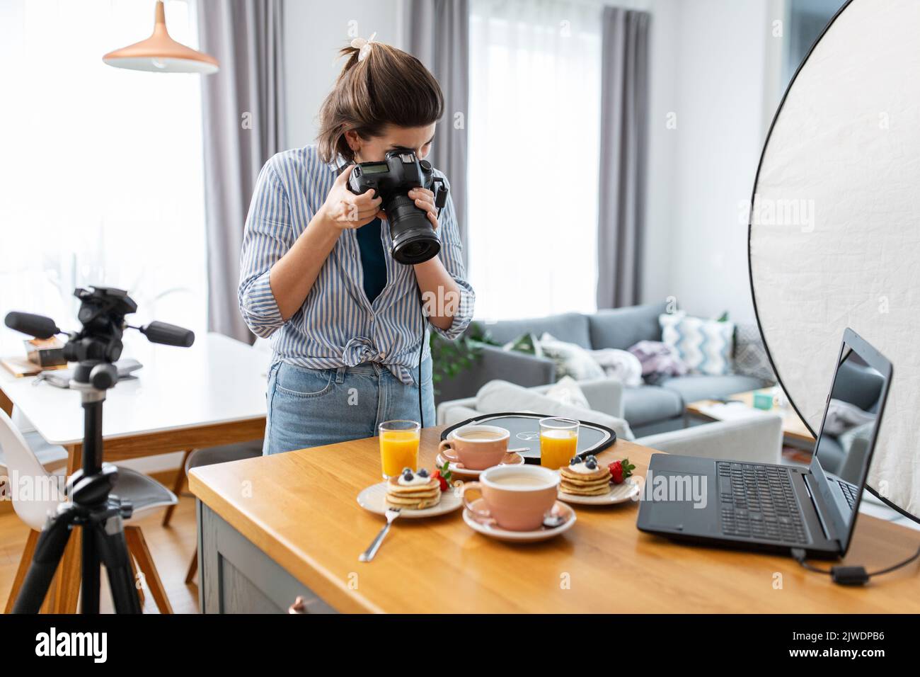 food photographer with camera working in kitchen Stock Photo - Alamy