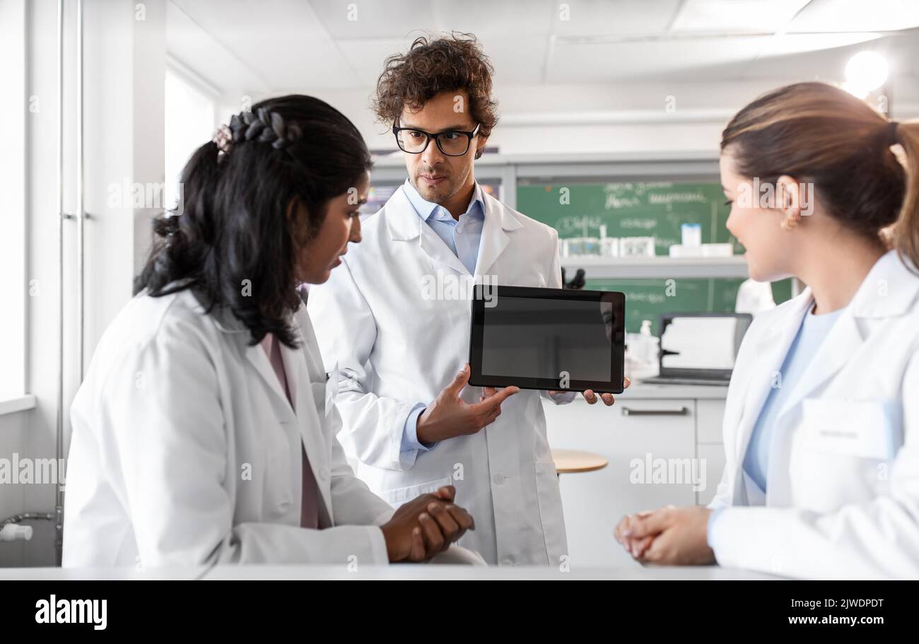 scientists with tablet pc working in laboratory Stock Photo - Alamy