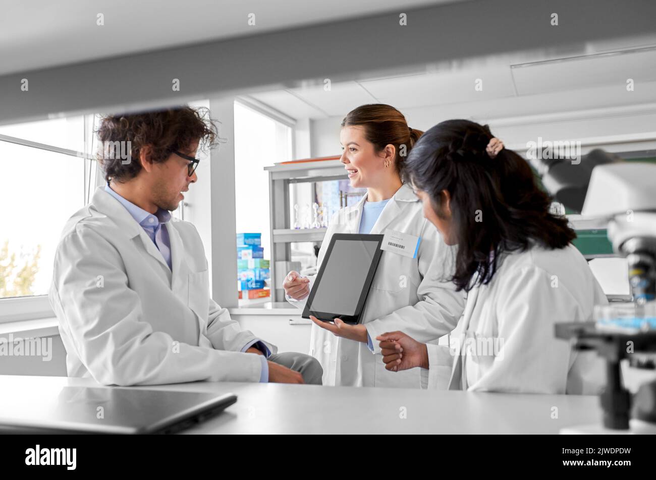 scientists with tablet pc working in laboratory Stock Photo - Alamy