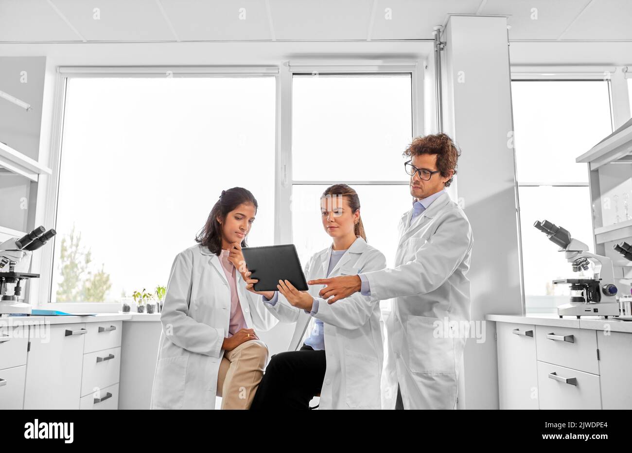 scientists with tablet pc working in laboratory Stock Photo - Alamy