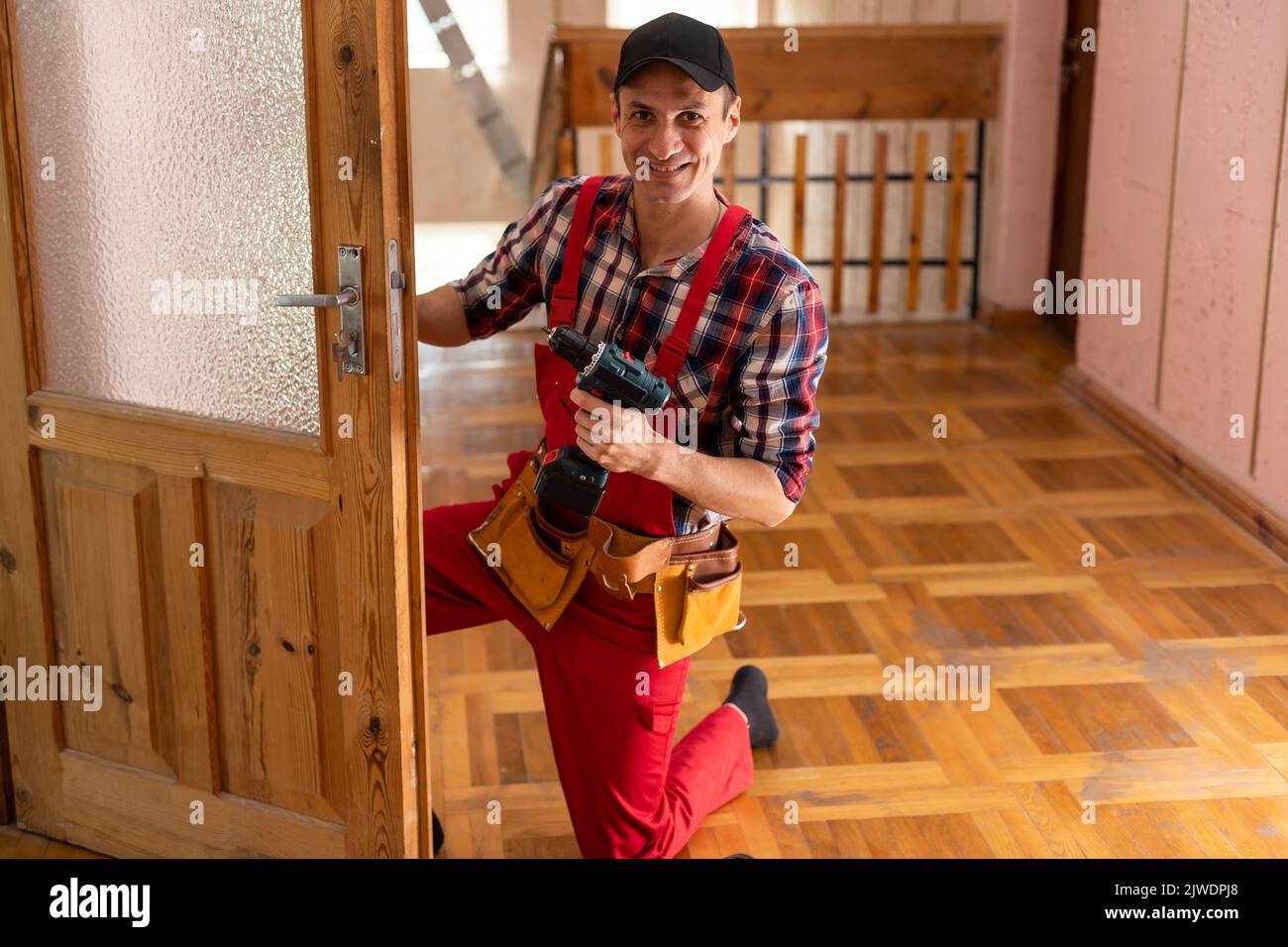 Installation of a lock on the entrance door Hand 's man with ...