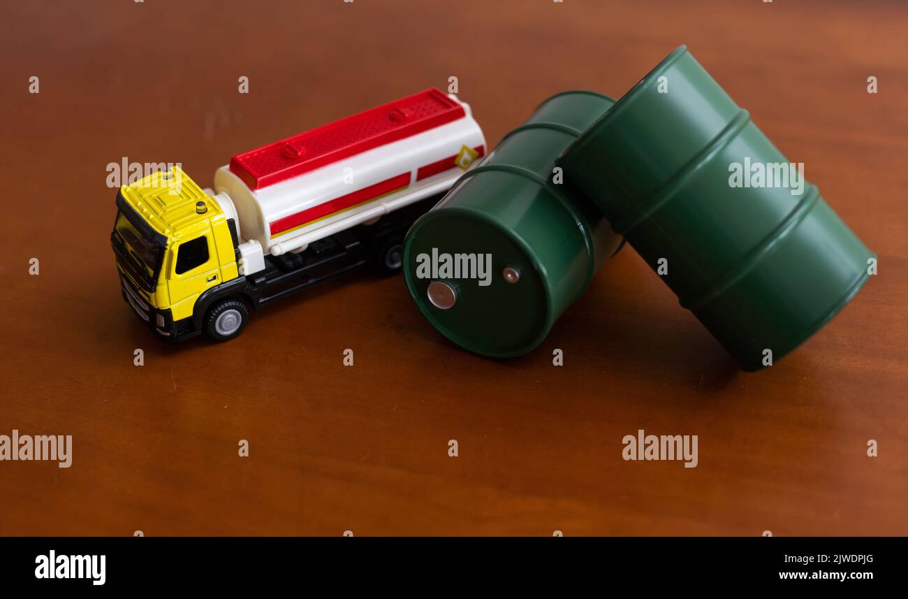 small toy combine with toy oil barrel Stock Photo - Alamy