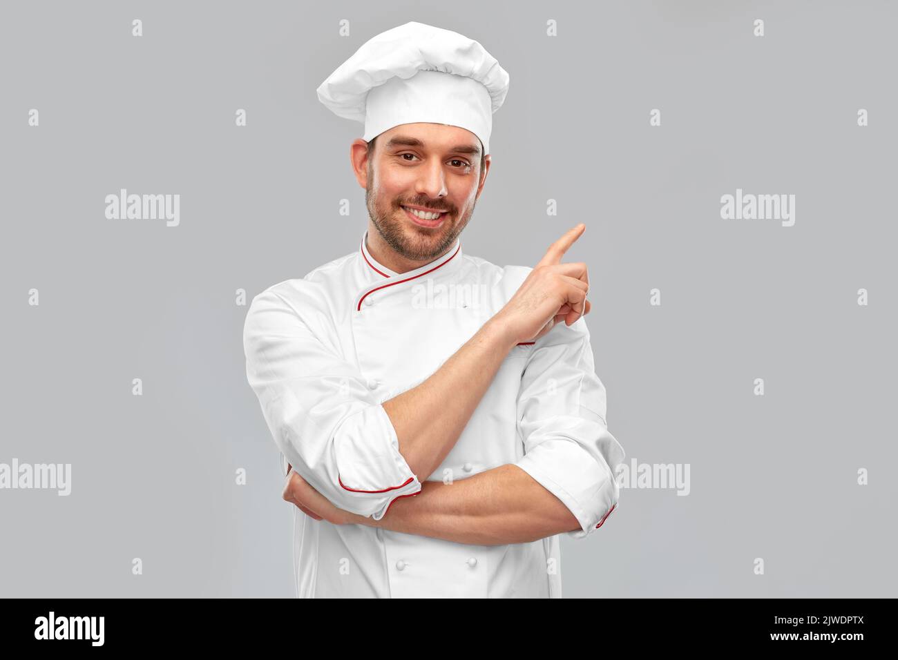 happy smiling male chef pointing to something Stock Photo - Alamy
