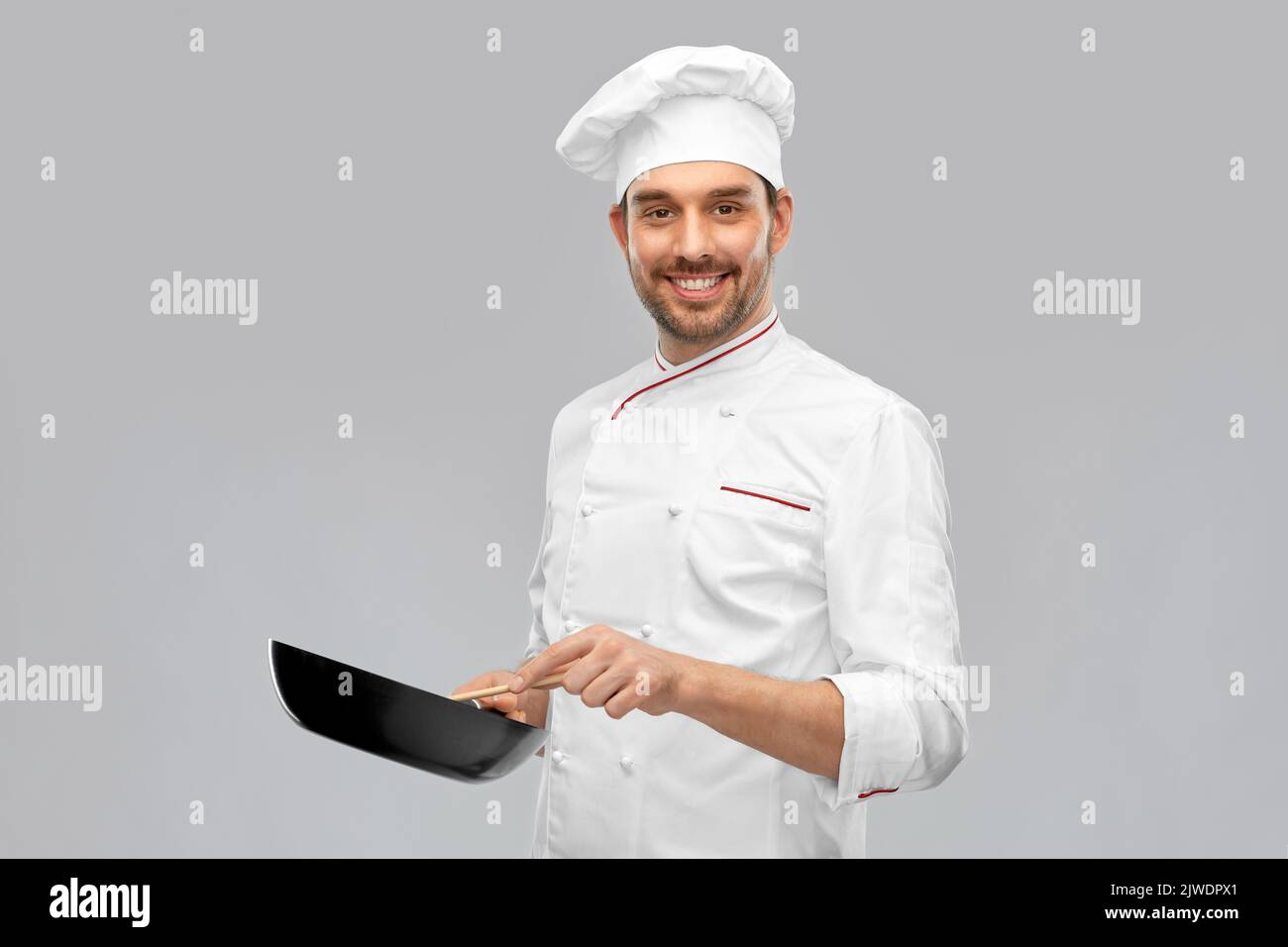 smiling male chef with frying pan cooking food Stock Photo - Alamy