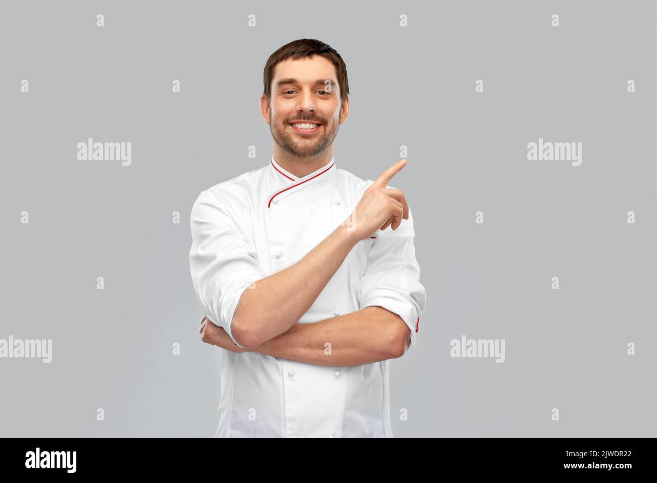 happy smiling male chef pointing to something Stock Photo - Alamy