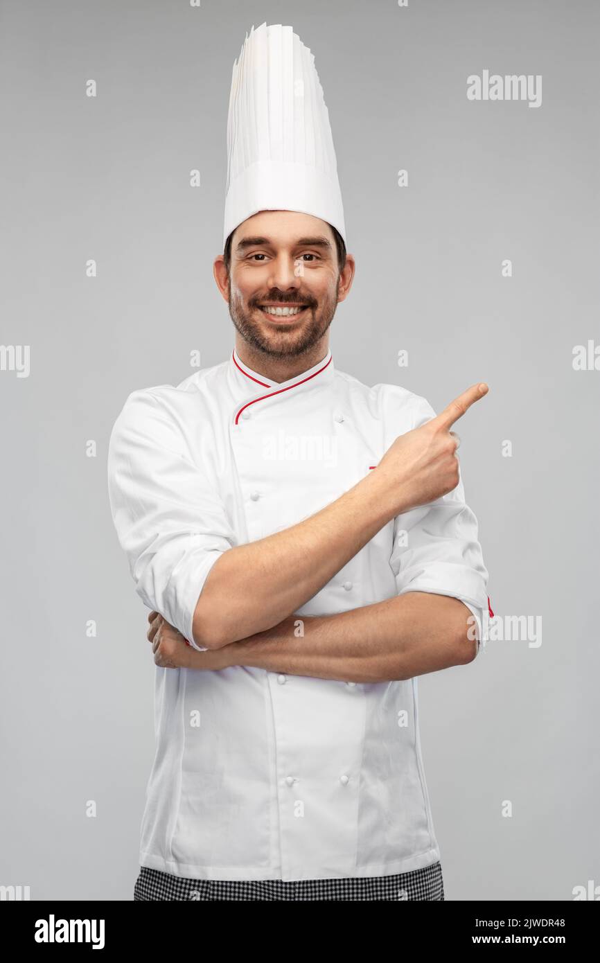 happy smiling male chef in toque pointing finger Stock Photo - Alamy
