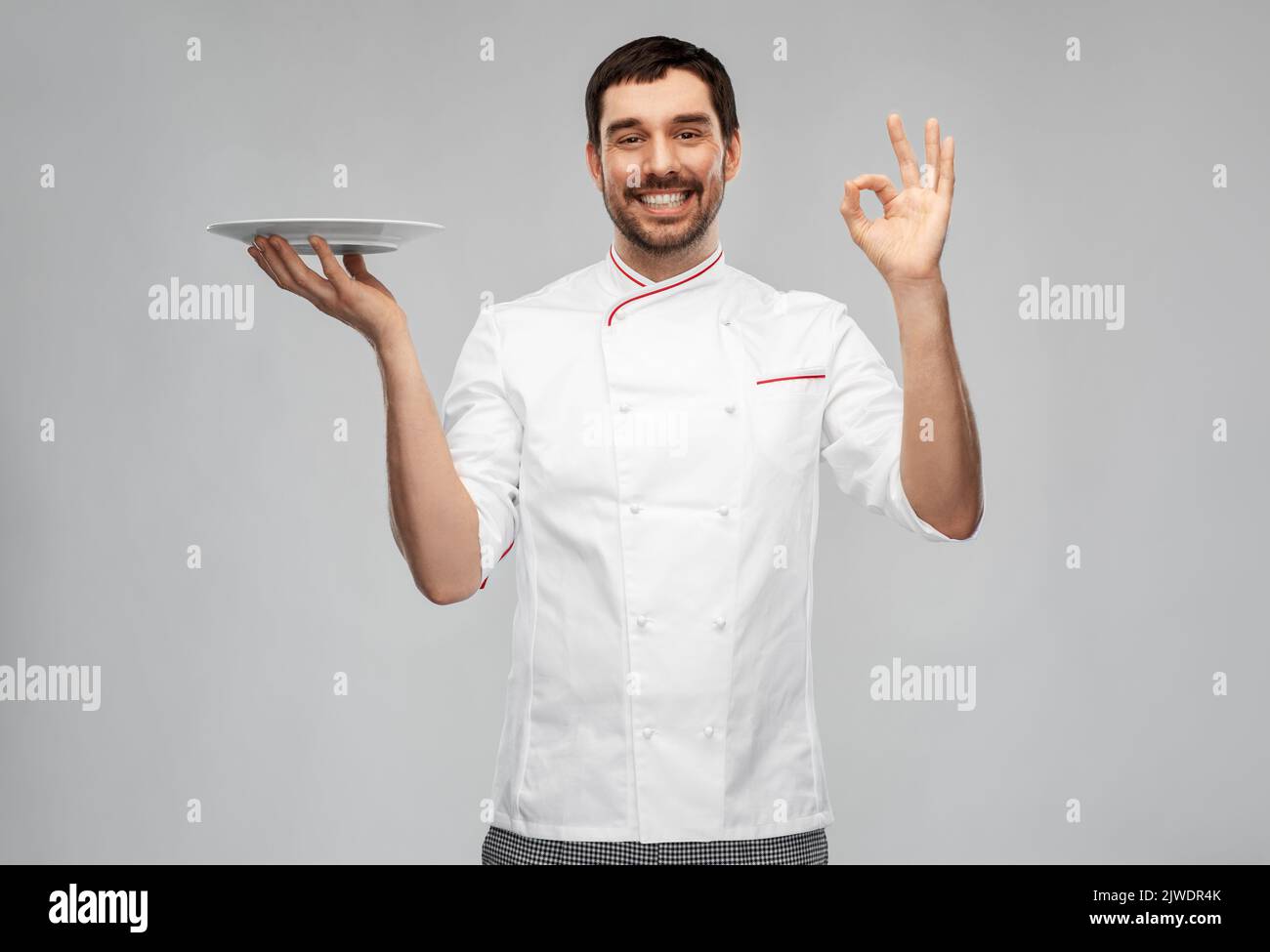 happy smiling male chef holding empty plate Stock Photo - Alamy
