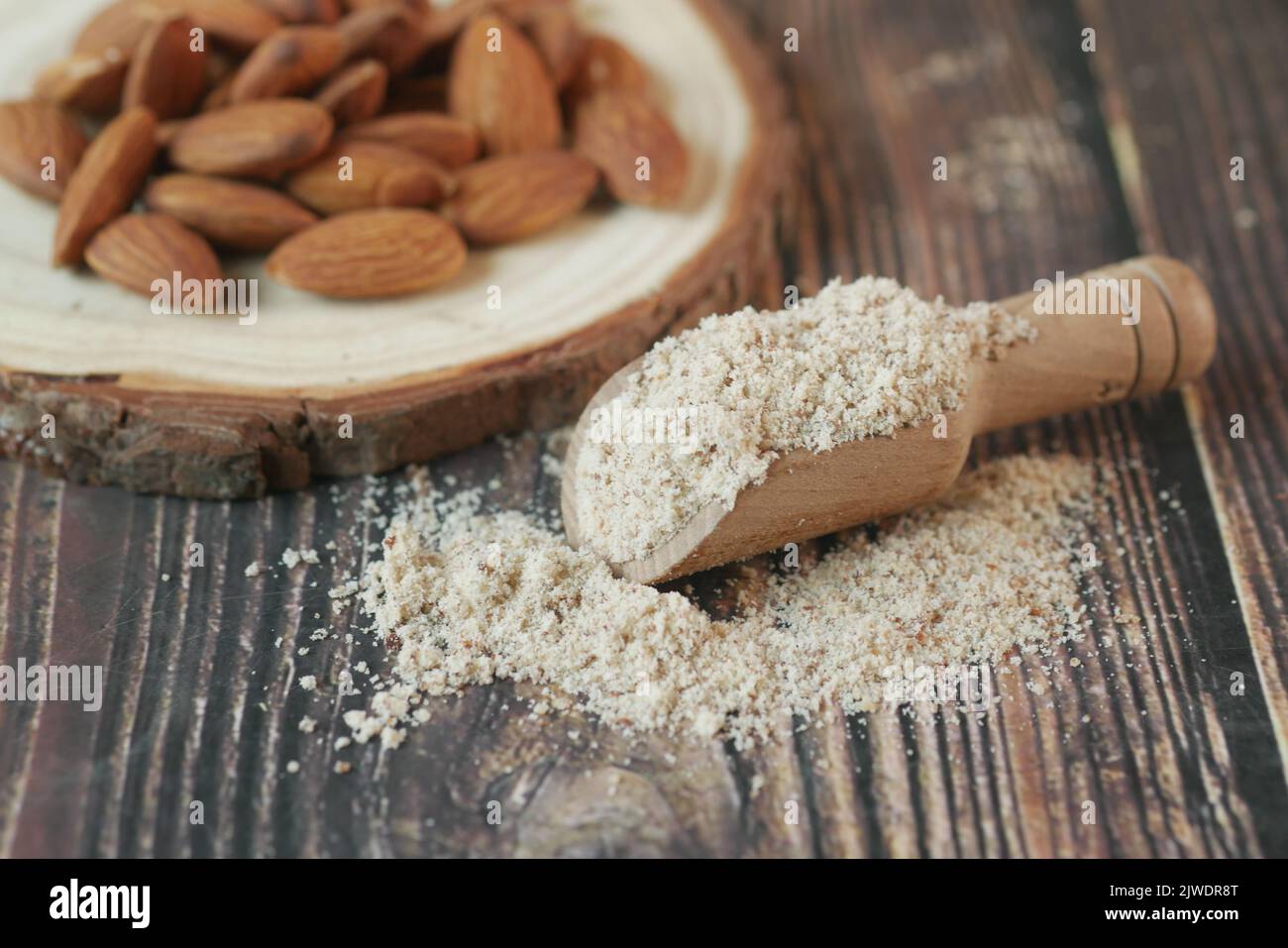 almond powder in a wooden spoon on table Stock Photo - Alamy