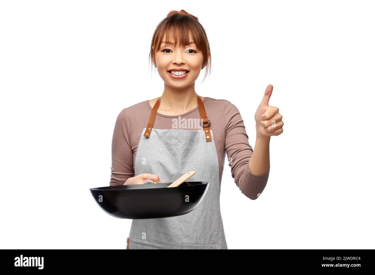 happy woman with frying pan showing thumbs up Stock Photo - Alamy