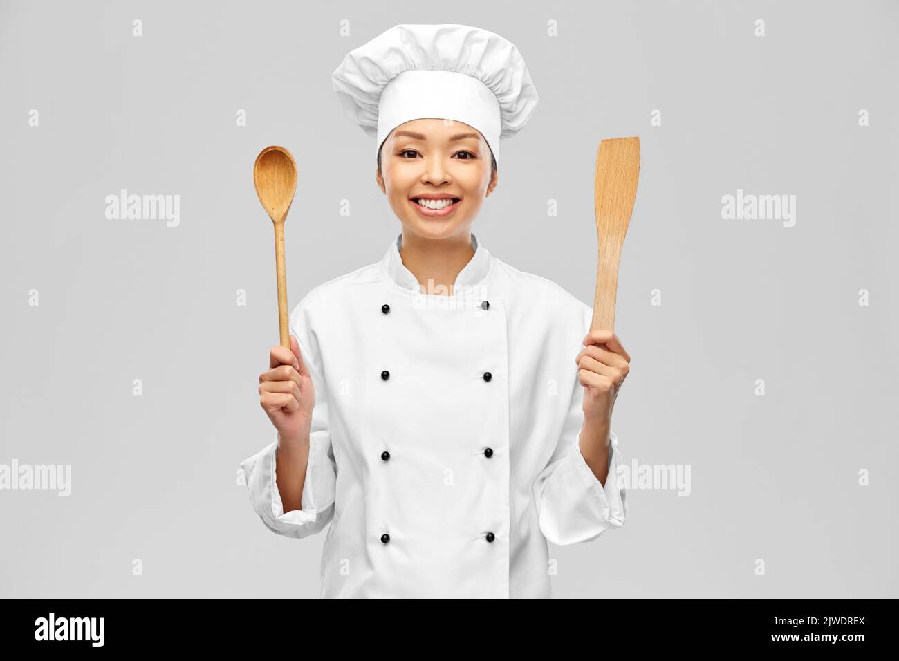happy smiling female chef with wooden spoon Stock Photo - Alamy