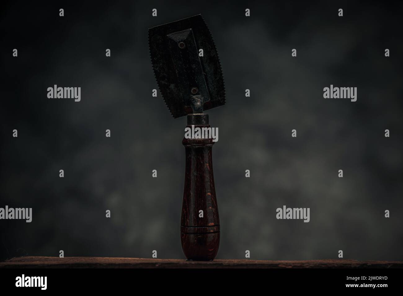 picture of old rusty particle board handsaw on top of wooden workbench ...