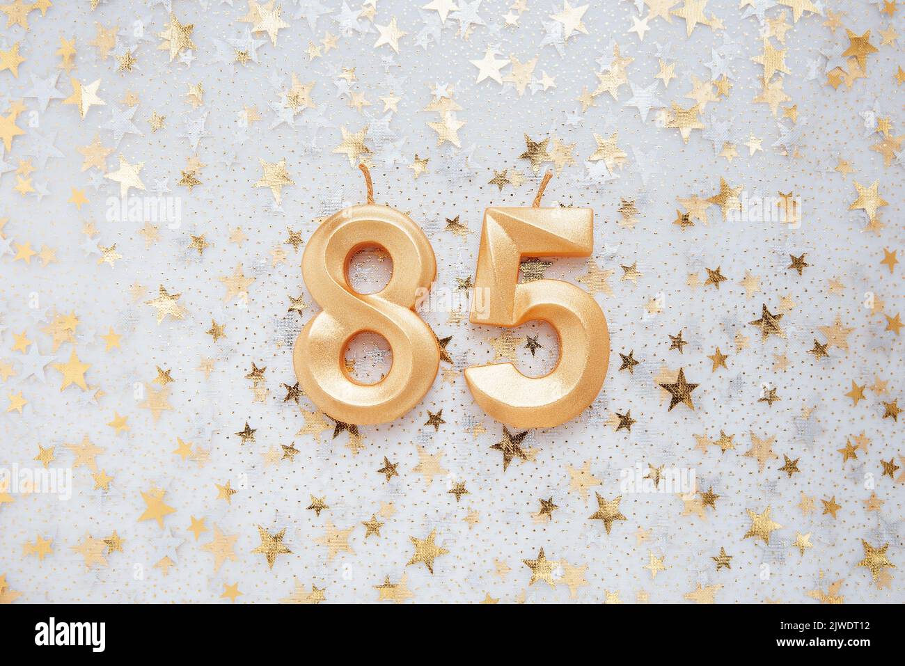Number 85 eighty five golden celebration birthday candle on Festive ...