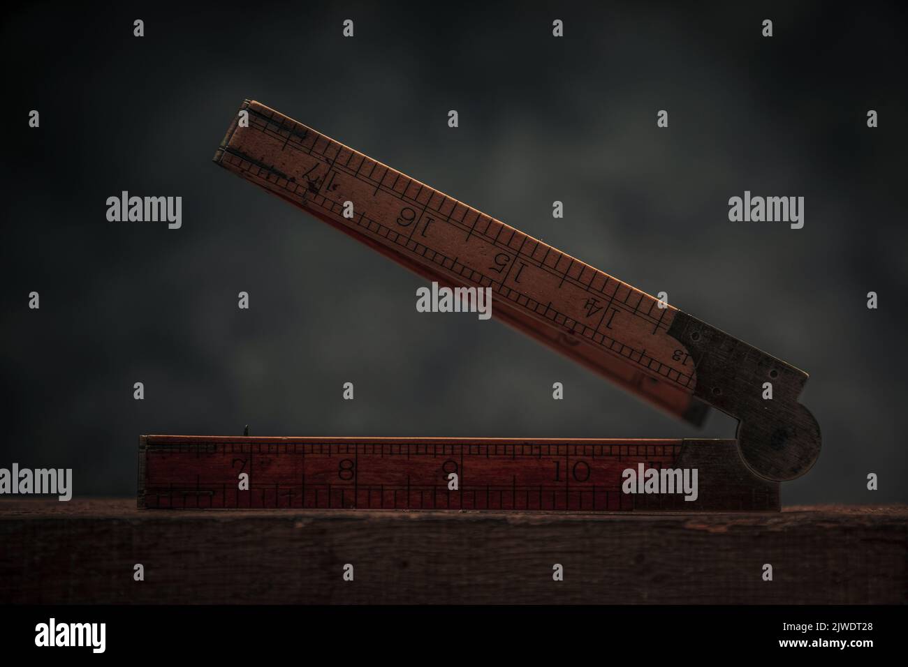 close up picture of measuring wooden ruler on top of old workbench ...