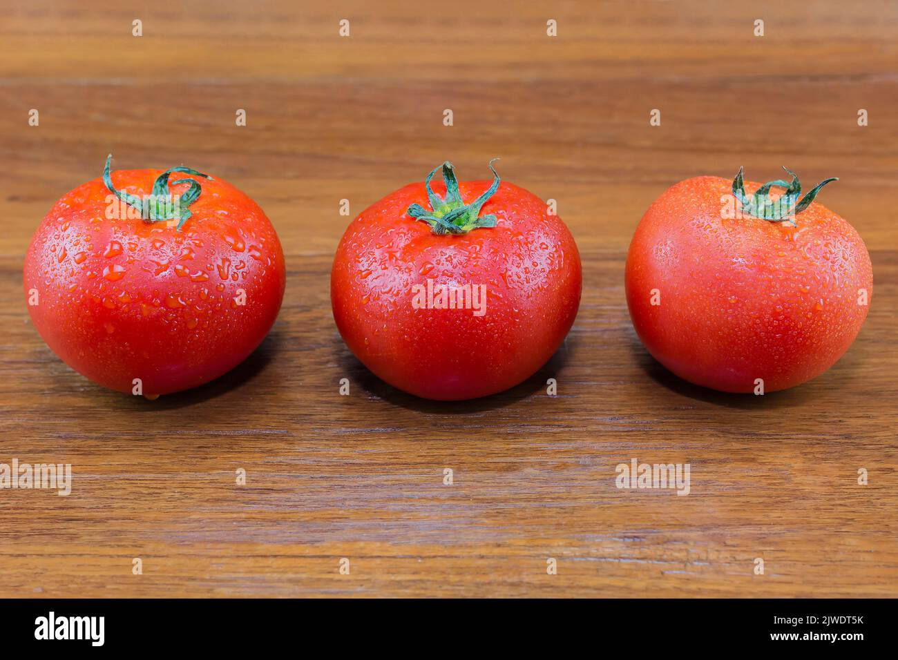 Tomato slides on the wooden floor Stock Photo - Alamy