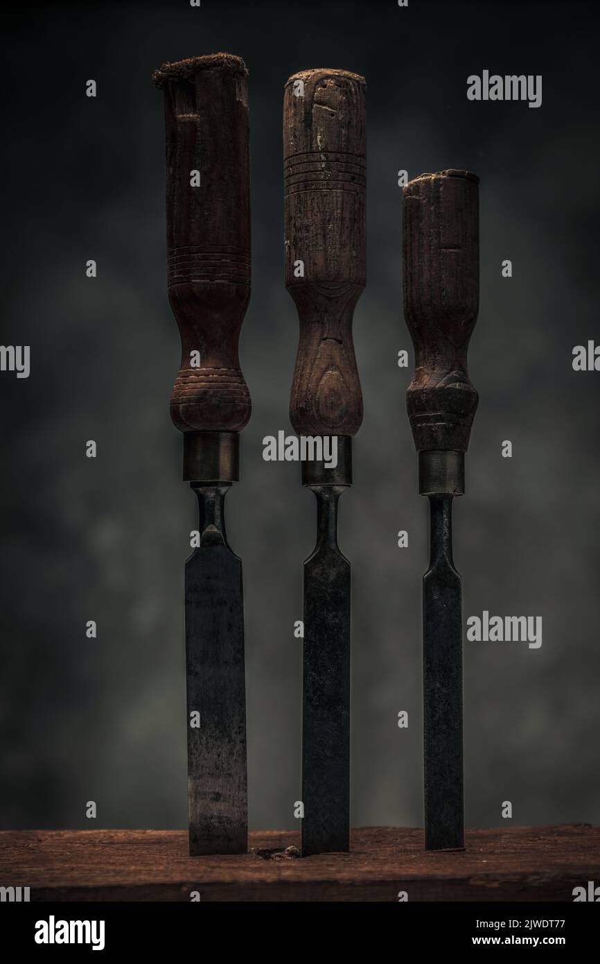 picture of three old rusty chisels for carpentry and sculpting on top ...